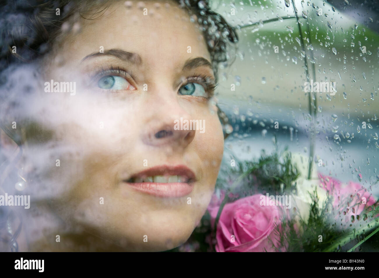 Photo of pretty face of bride through window of car Stock Photo - Alamy