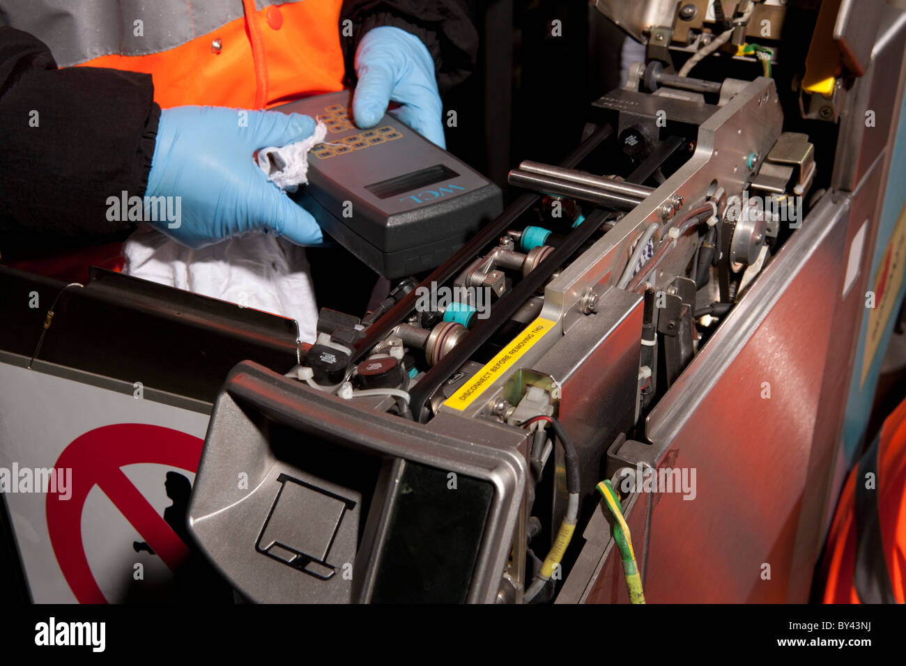 london underground engineer working at night on maintenance of ticket ...