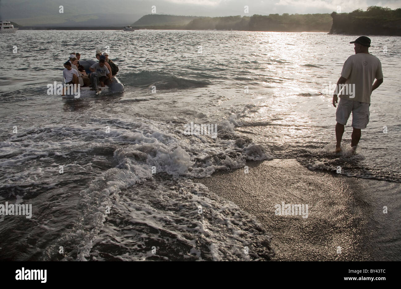Wet Landing with inflatable rubber boat on sandy seashore Santiago ...