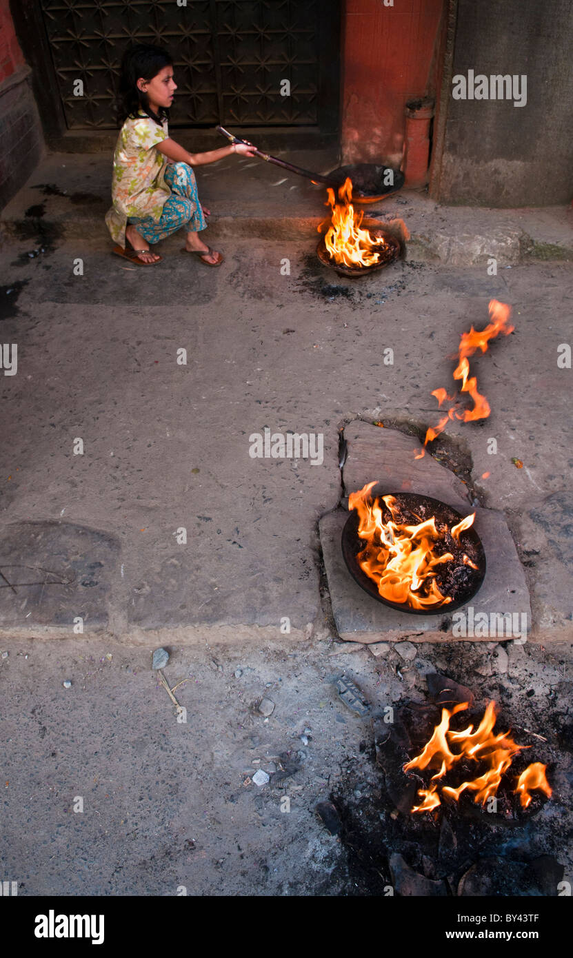 little girl making fire puja at a temple in Kathmandu, Nepal Stock ...