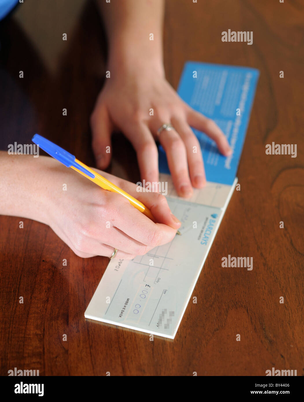 Signing a cheque uk hi-res stock photography and images - Alamy