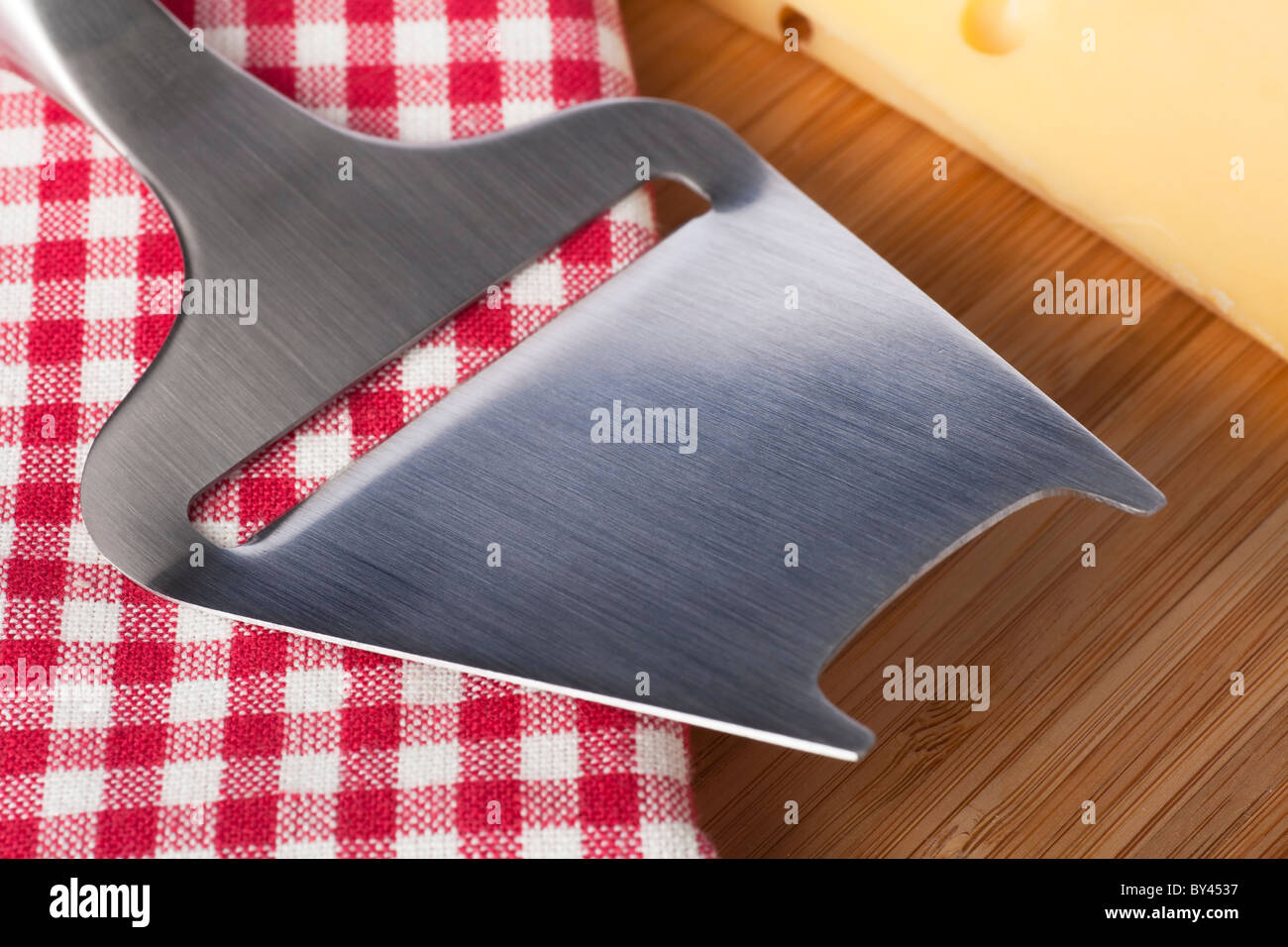 Close up of metal cheese slicer Stock Photo - Alamy