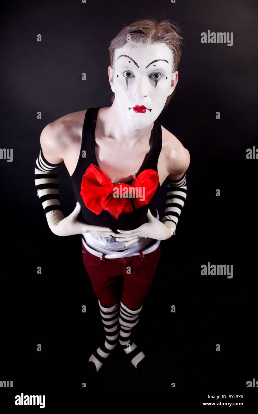 Mime with a big red bow on a black background Stock Photo - Alamy