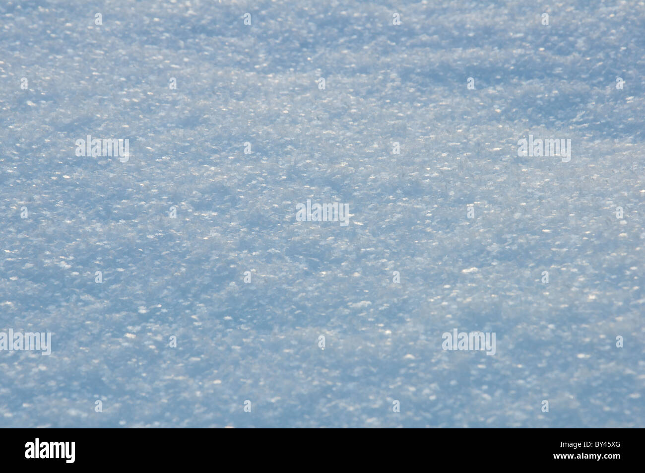 Snowy field with beautiful white and blue snowflakes Stock Photo - Alamy