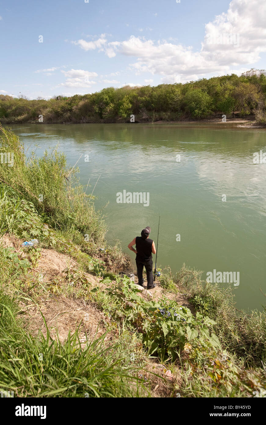 Man fishing on the United States side of the Rio Grande River, border ...