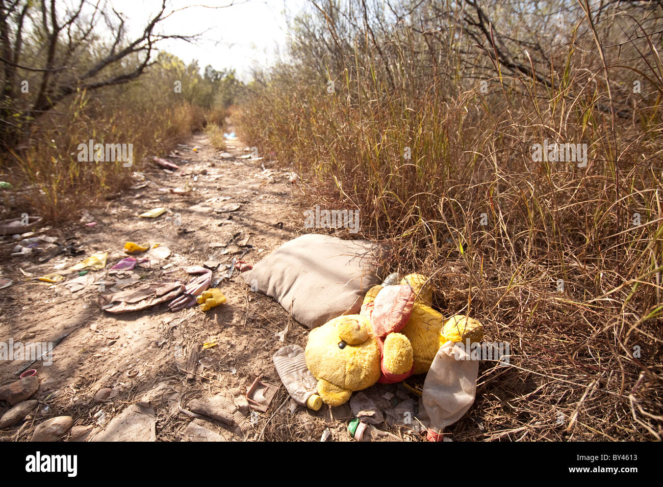 Trash-strewn path from the Rio Grande River, the border between the ...