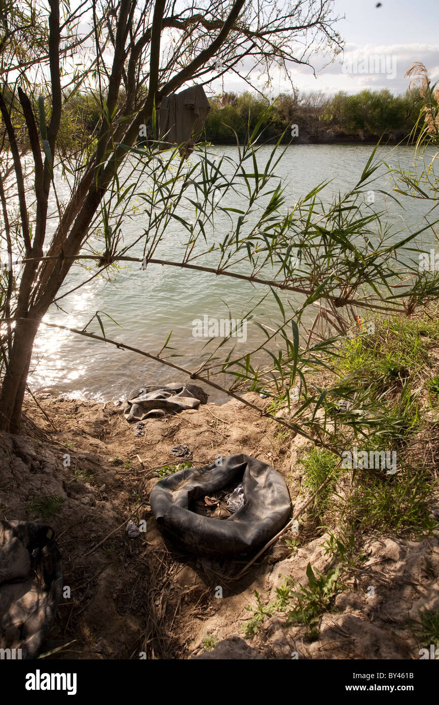 Deflated tire inner tubes on a trash-strewn path from the Rio Grande ...