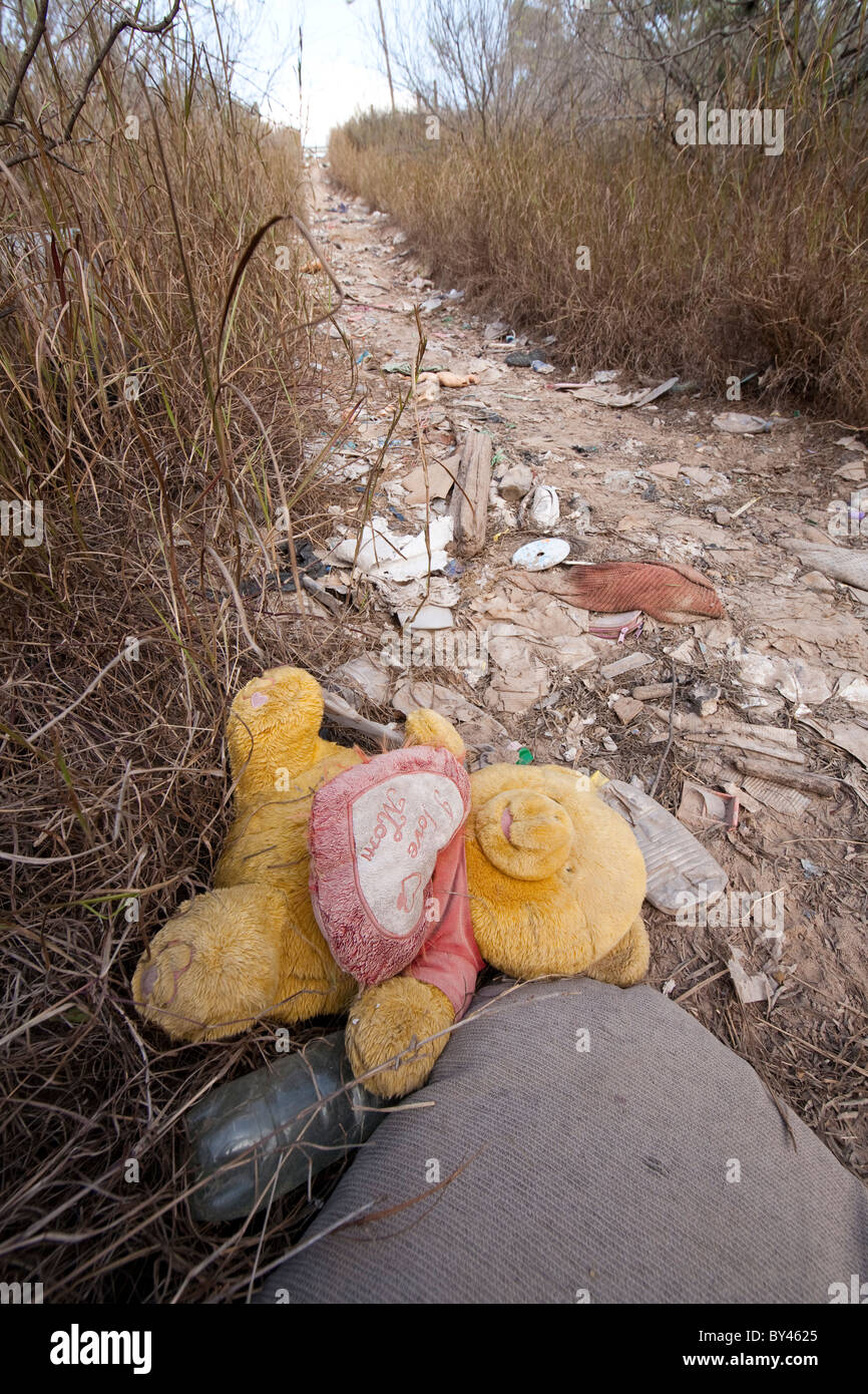 Trash-strewn path from the Rio Grande River, the border between the ...