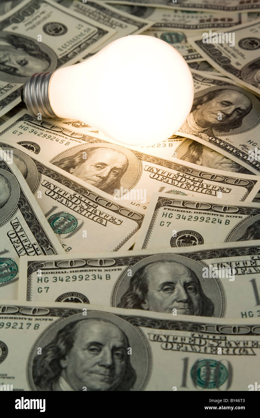 Bright Light Bulb and Dollar close up shot Stock Photo - Alamy