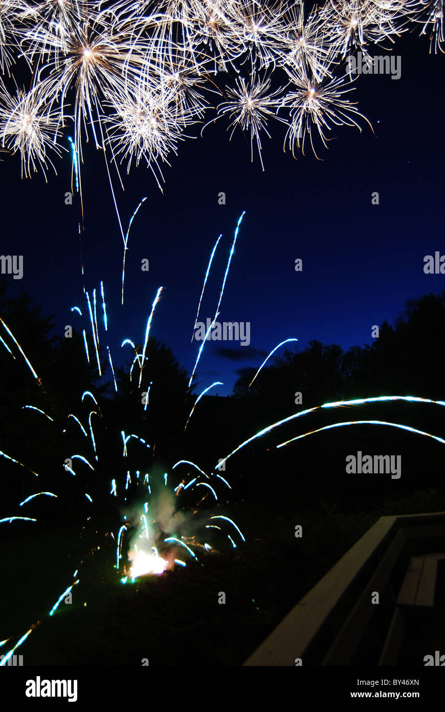 Fireworks exploding high in the air, and low to the ground Stock Photo ...