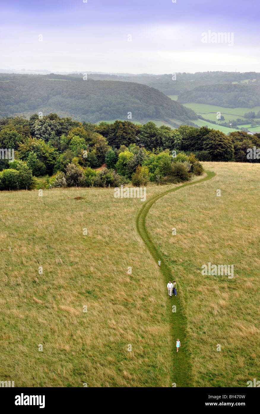 A family walking on The Cotswold Way path near North Nibley ...