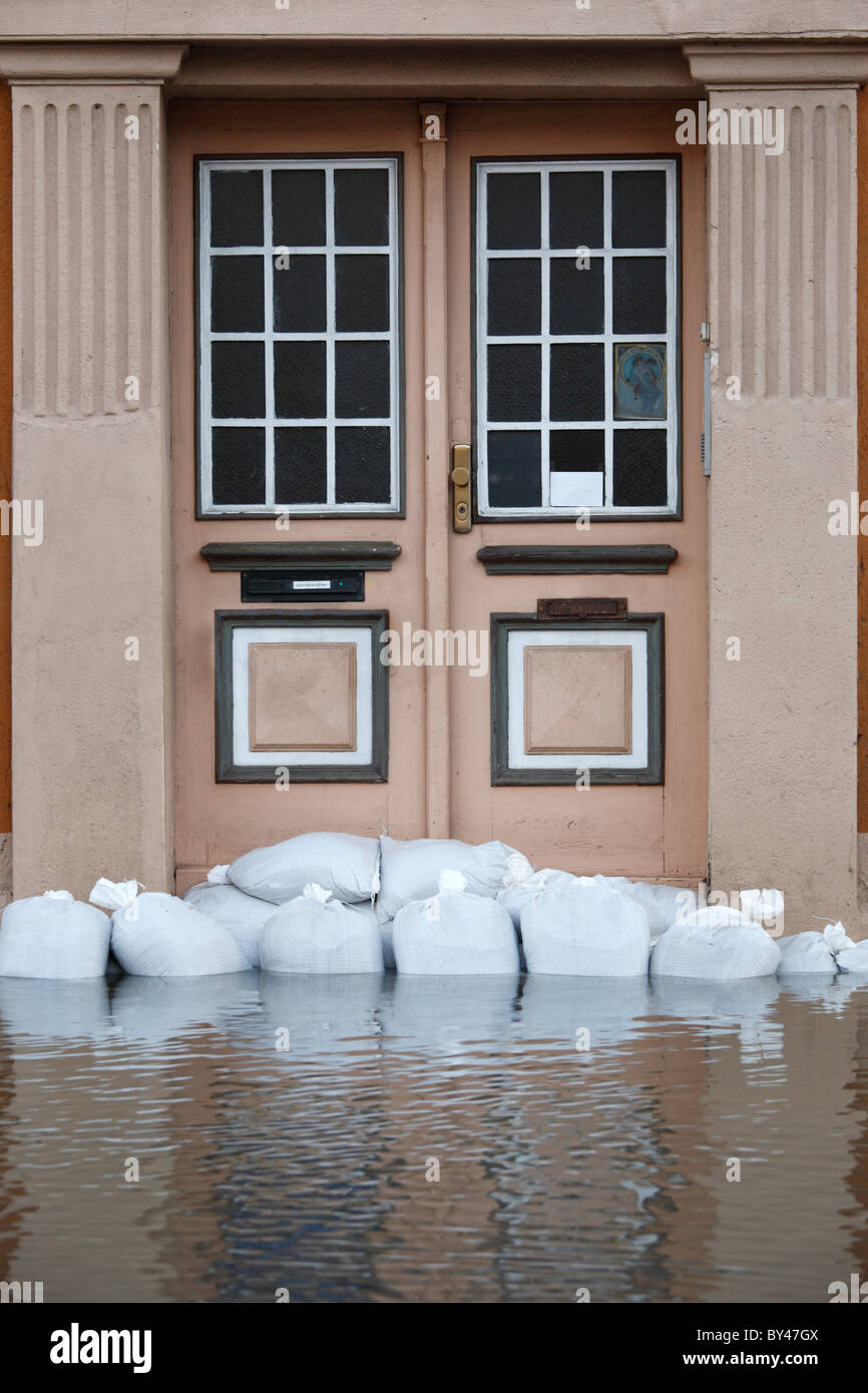 sandbags across the door of a house as protection against flooding of ...