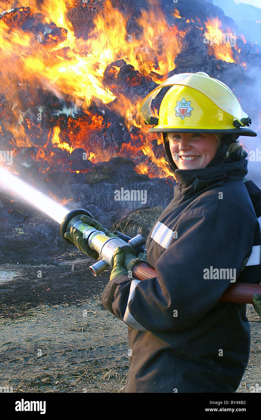 female fire-fighter at large fire, fire woman Stock Photo - Alamy