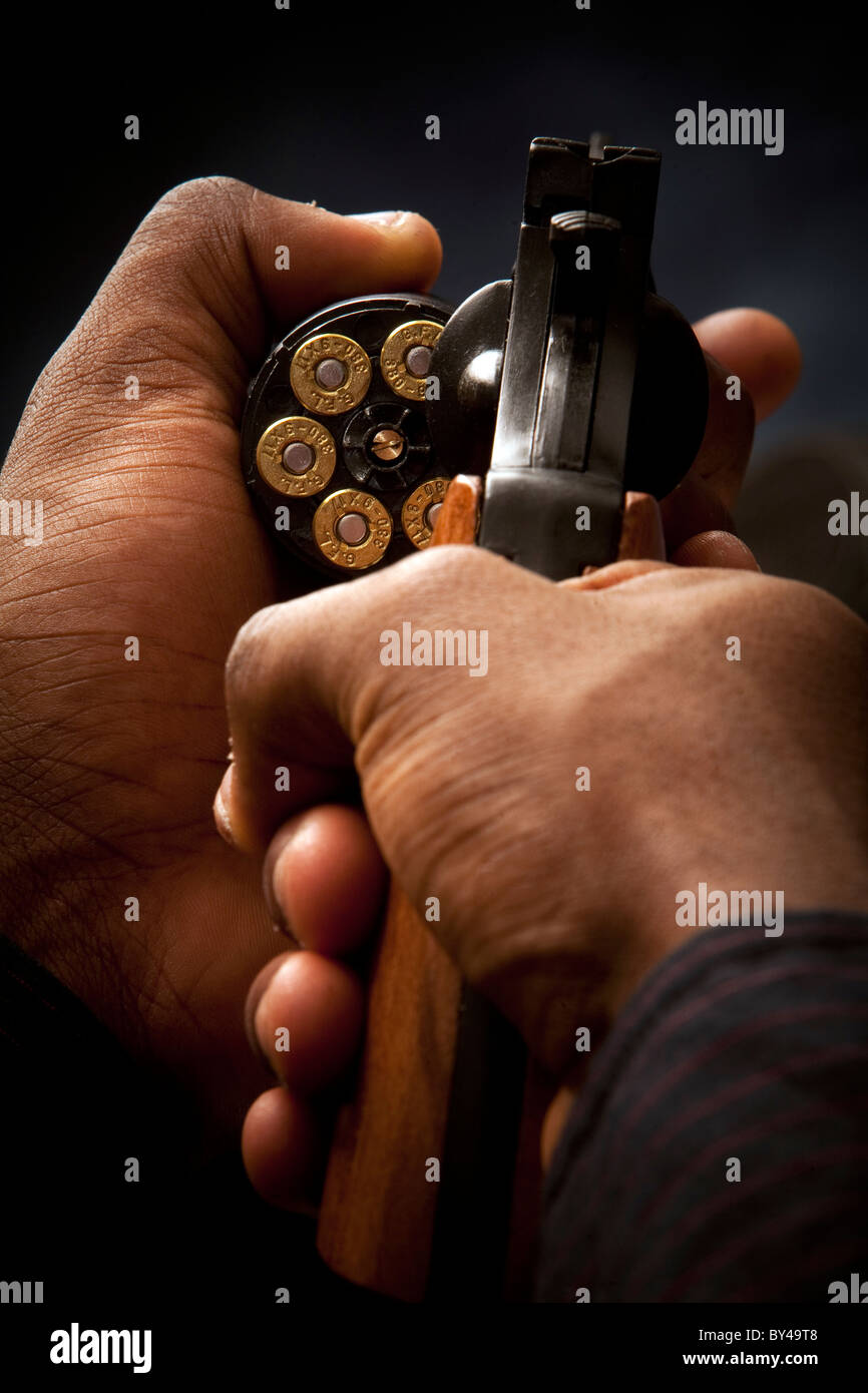 Young black male checking a gun Stock Photo - Alamy