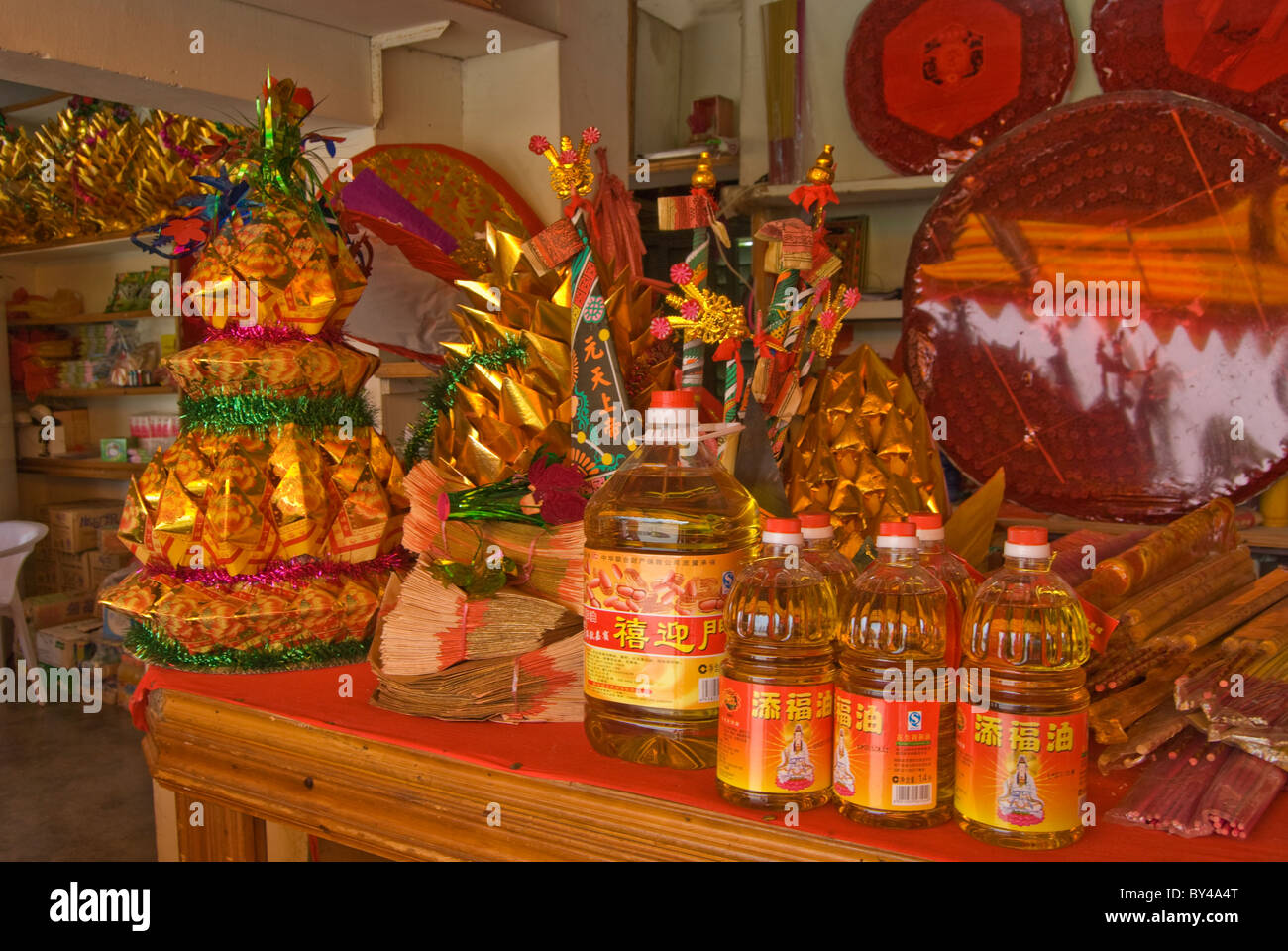 Several kinds of Chinese offerings to the Gods are sold in front of a ...