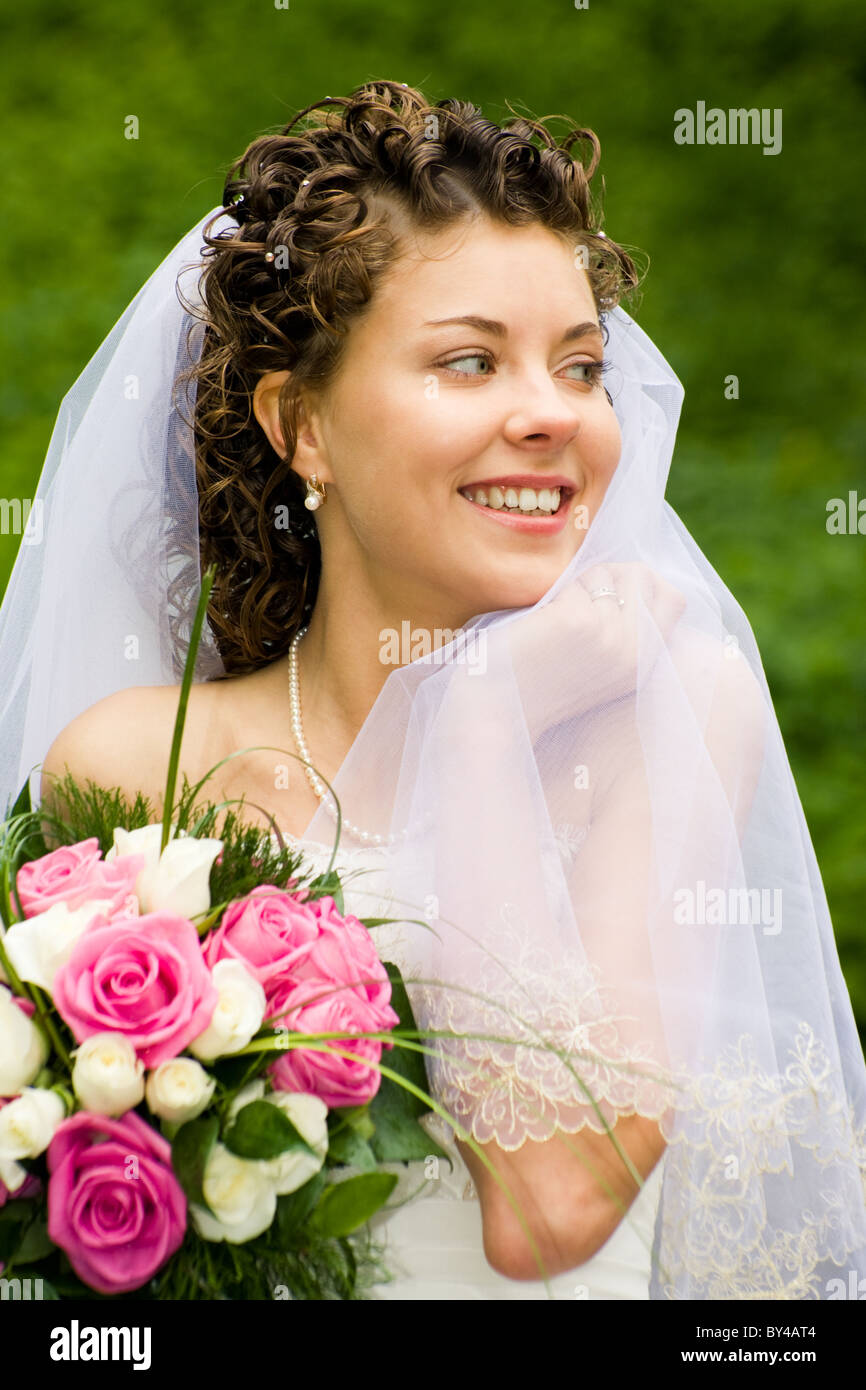 Portrait of beautiful bride with smile holding the bouquet Stock Photo ...
