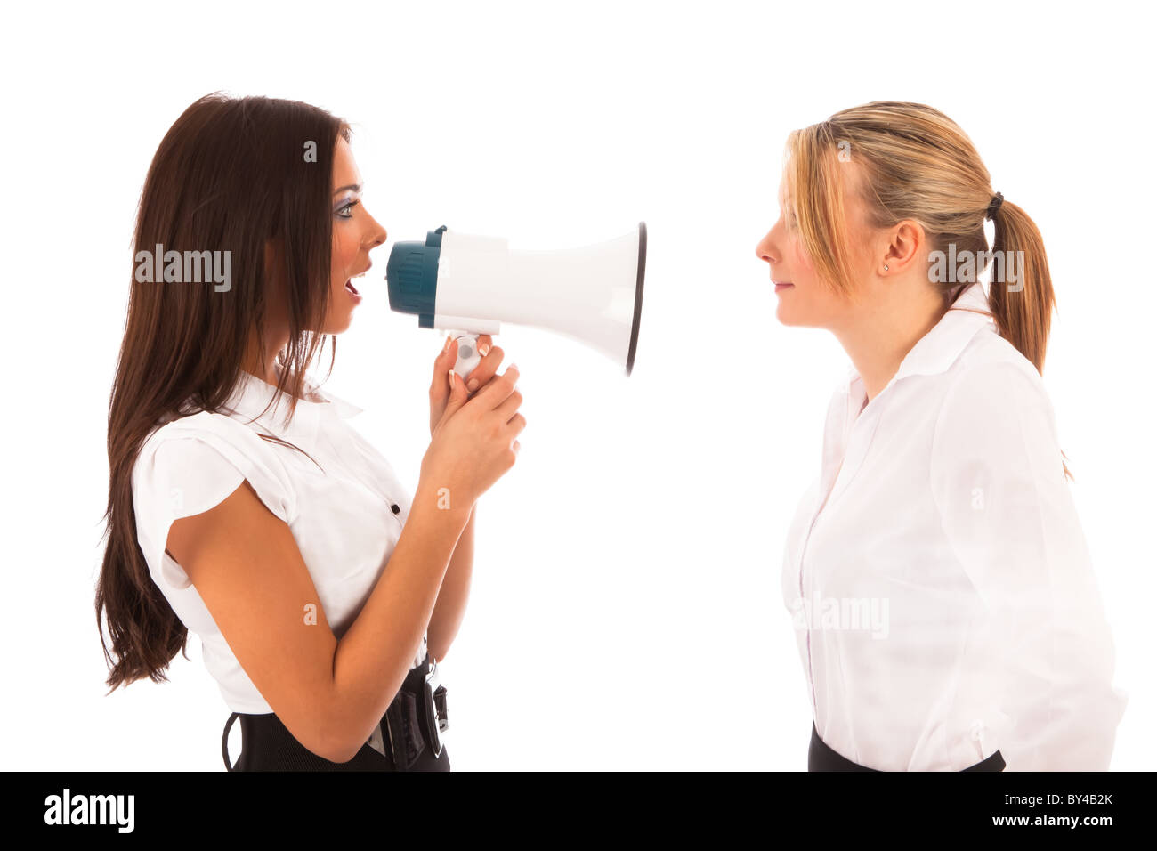 One business woman shouting at another through a megaphone Stock Photo ...
