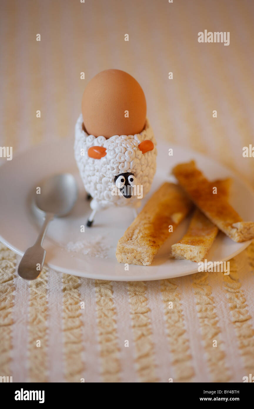 Childrens sheep egg cup with boiled egg and buttered soldiers Stock ...