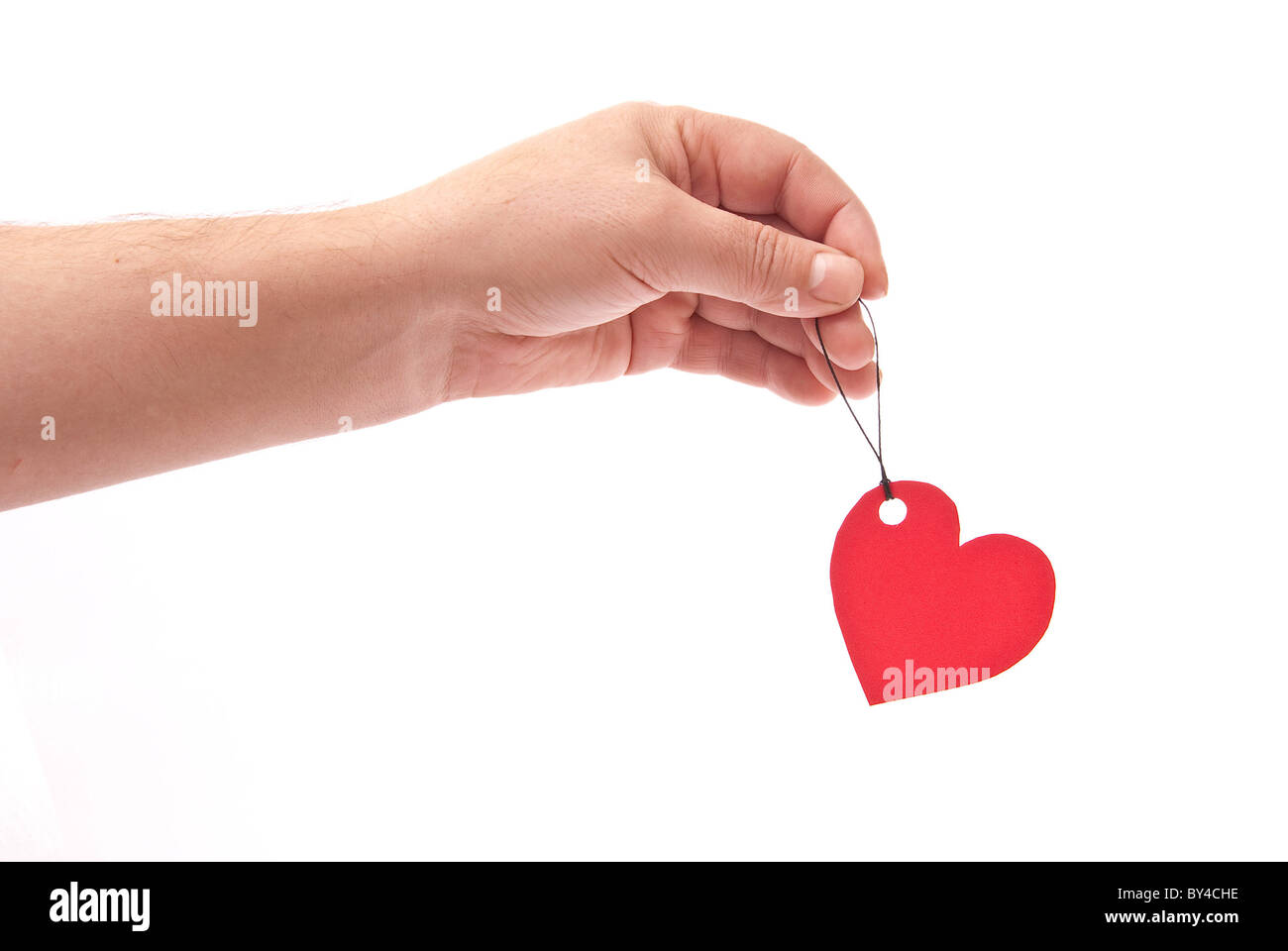 Hand with red heart tag Stock Photo - Alamy