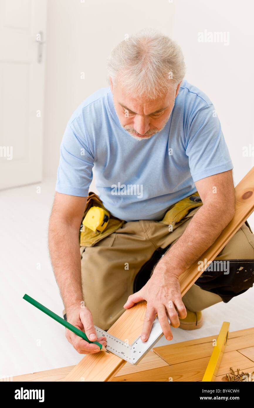 Home improvement - handyman installing wooden floor home Stock Photo ...