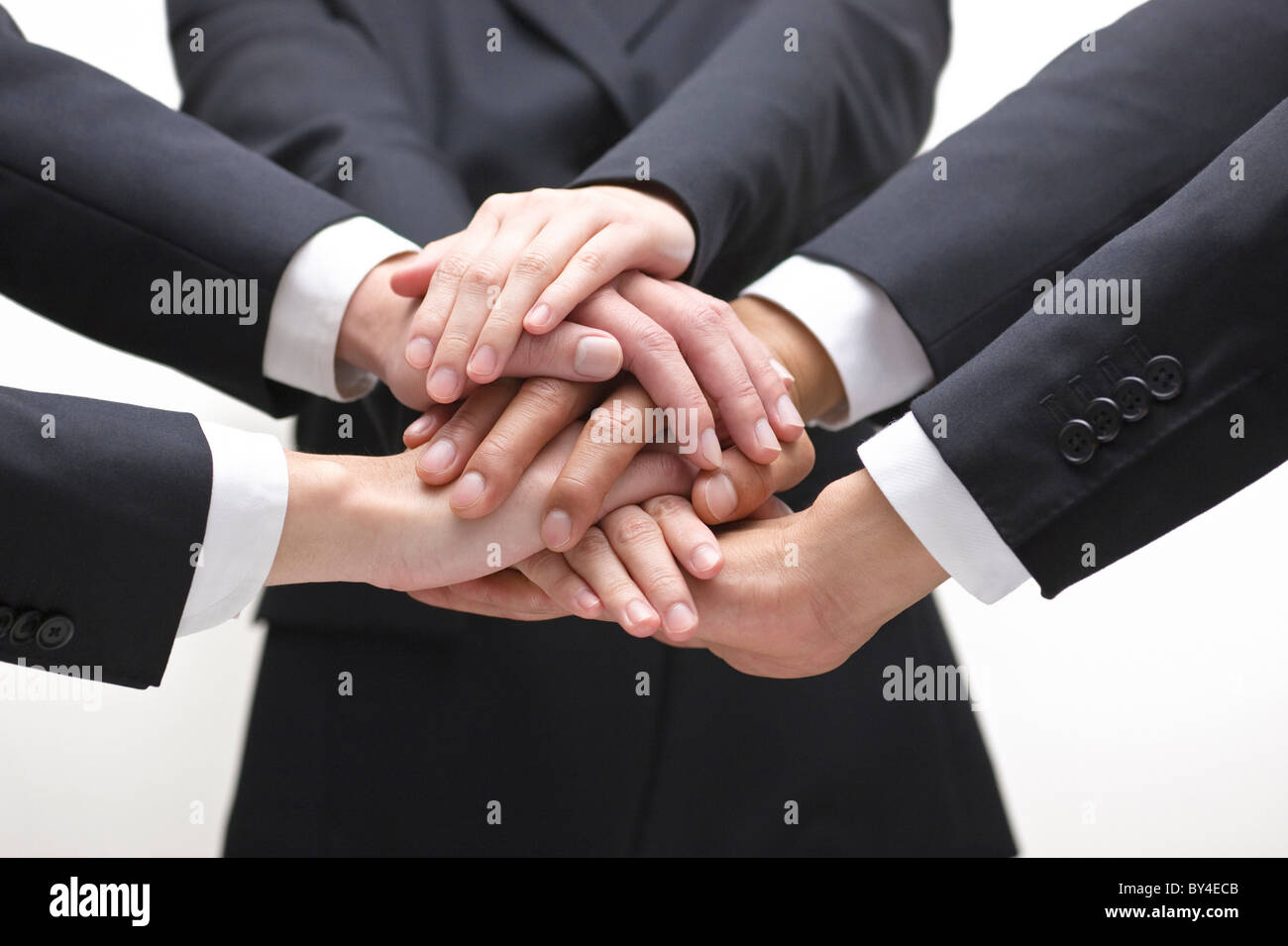 Business people stacking hands Stock Photo - Alamy