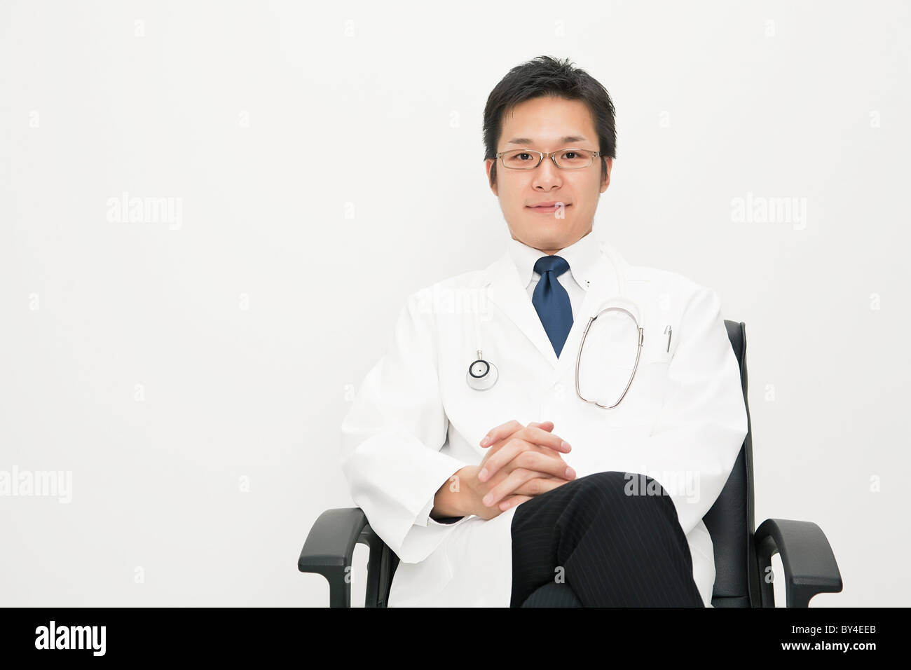 Doctor sitting on chair Stock Photo - Alamy