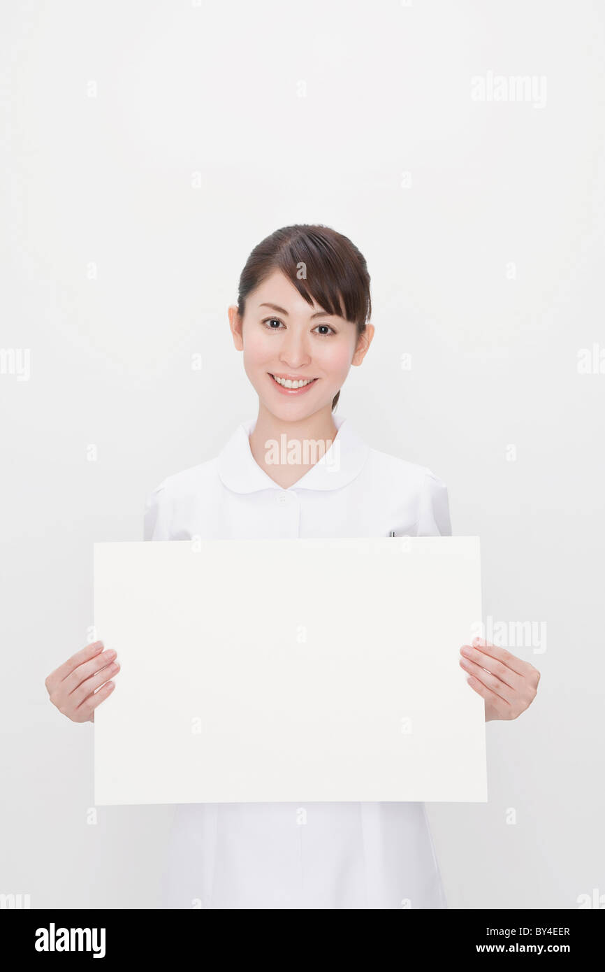 Nurse holding blank cardboard Stock Photo - Alamy