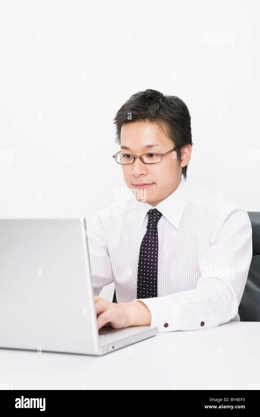 Businessman using a laptop Stock Photo - Alamy