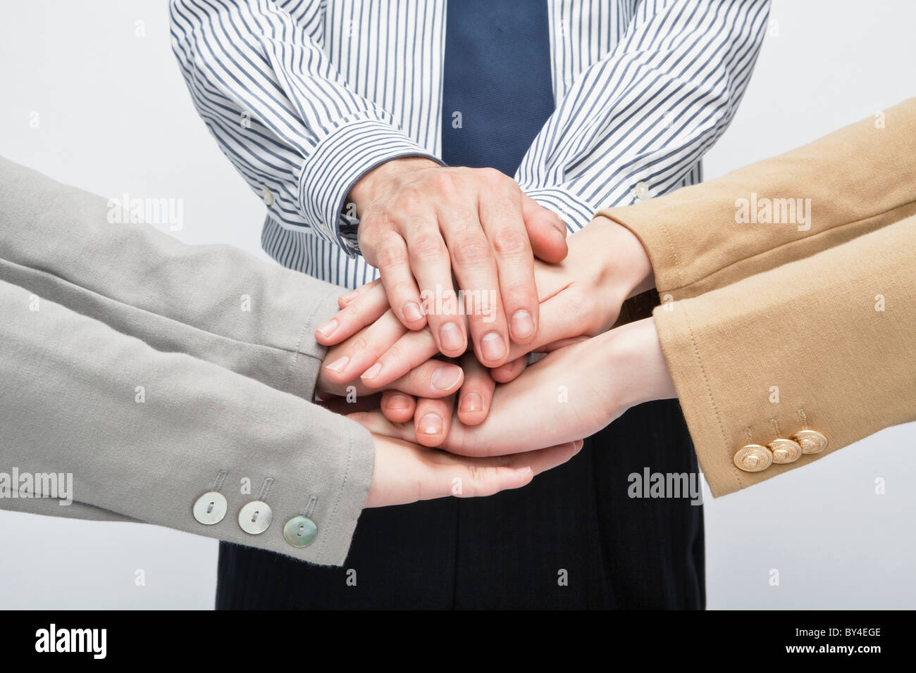 Business people stacking hands Stock Photo - Alamy