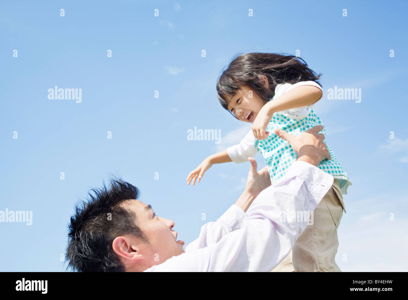 Father lifting up daughter Stock Photo - Alamy
