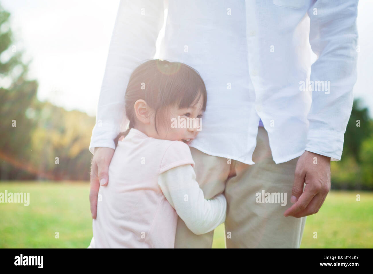 Girl embracing father's leg hi-res stock photography and images - Alamy