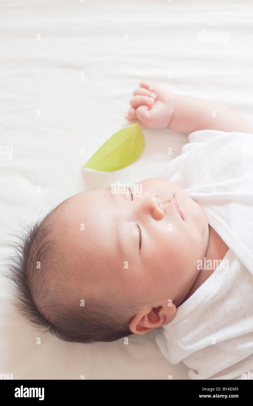 Baby lying down Stock Photo - Alamy