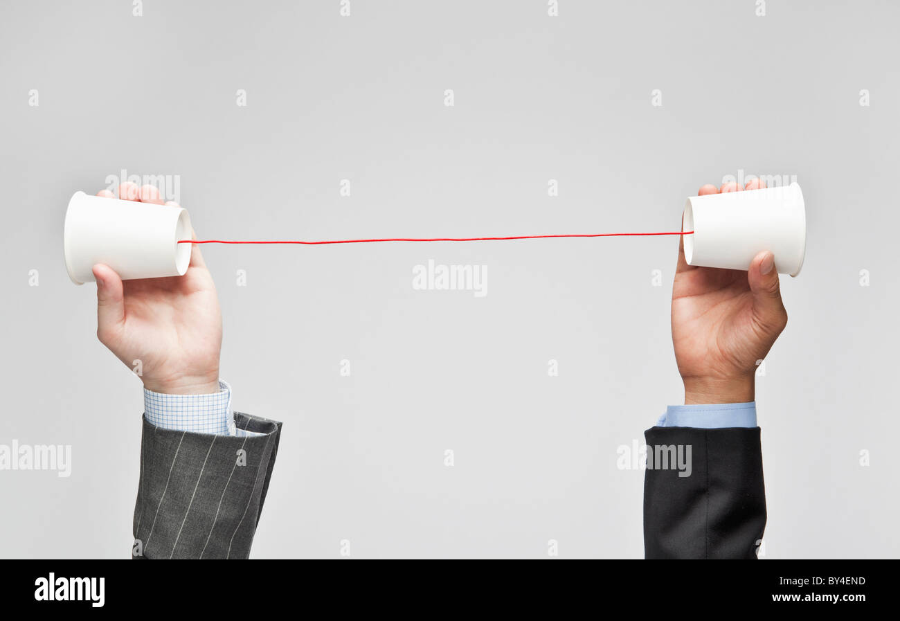 Businessman holding tin can phone hi-res stock photography and images ...