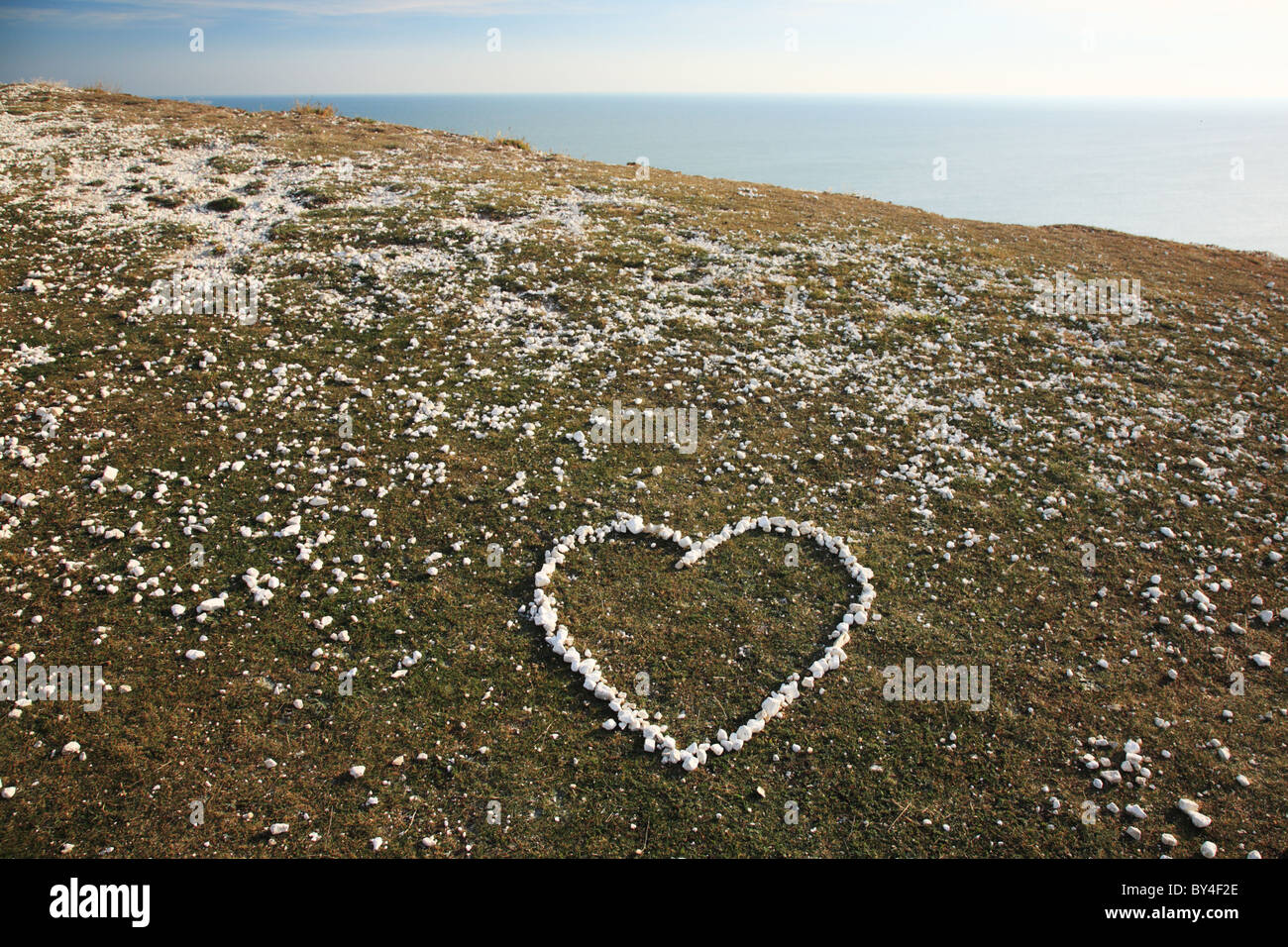 Love heart made from pebbles on the cliff top Stock Photo - Alamy
