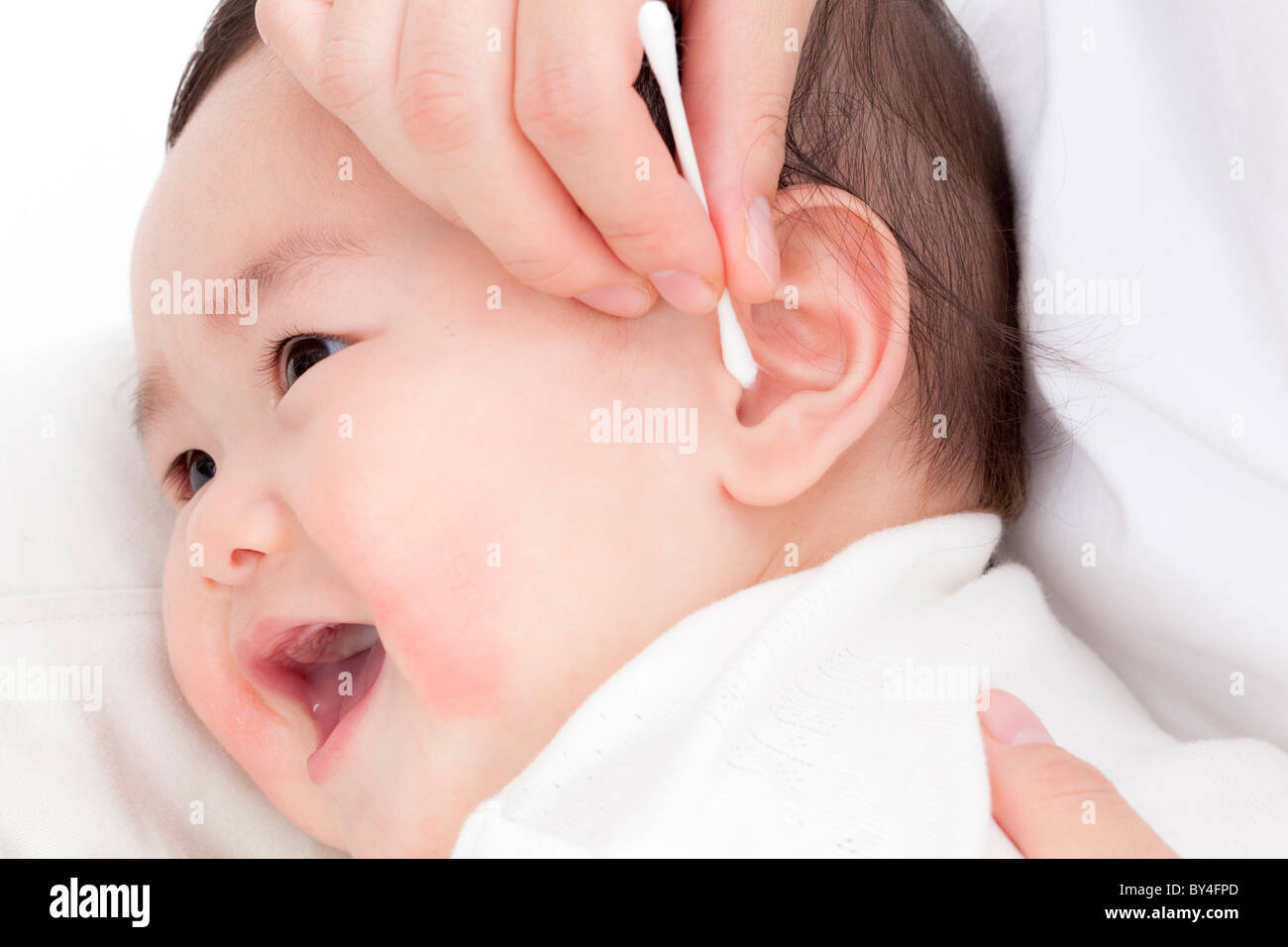 Mother Cleaning Baby's Ear Stock Photo - Alamy
