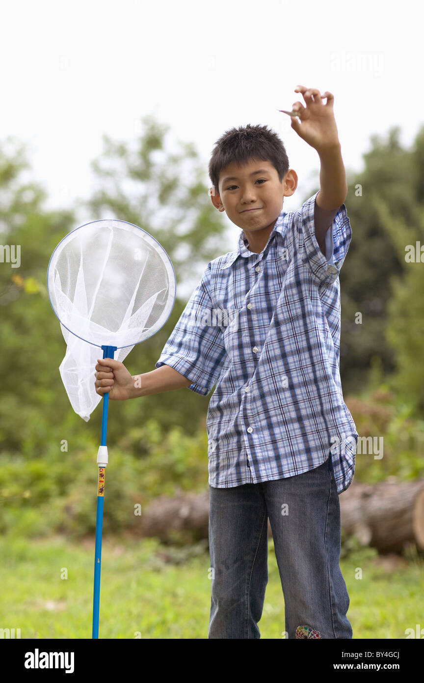 Boy Holding Up Insect Stock Photo - Alamy