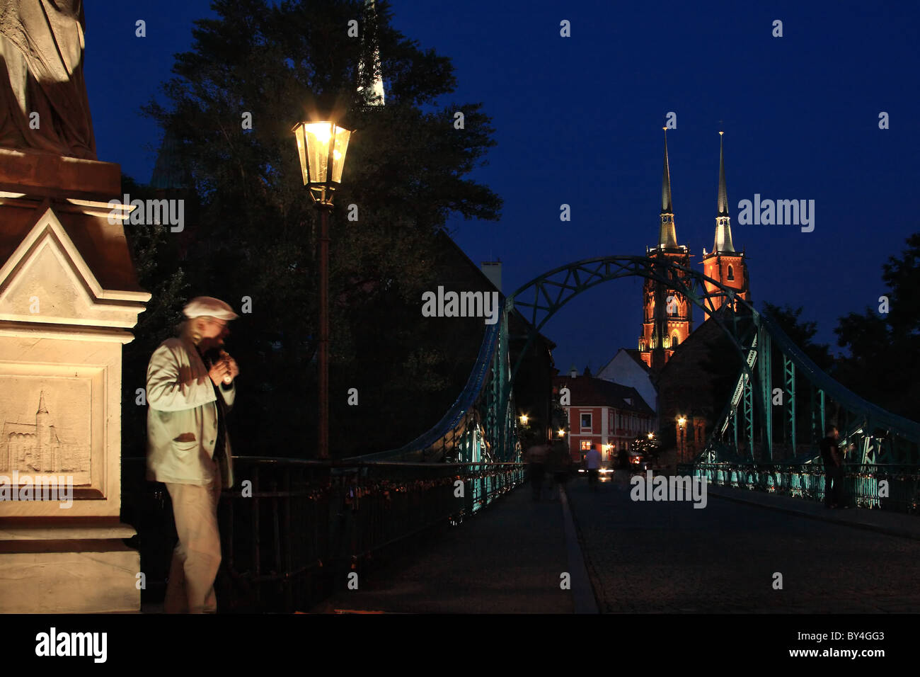 Busker playing flute on Tumski Brigde, Cathedral of St. Johns the ...