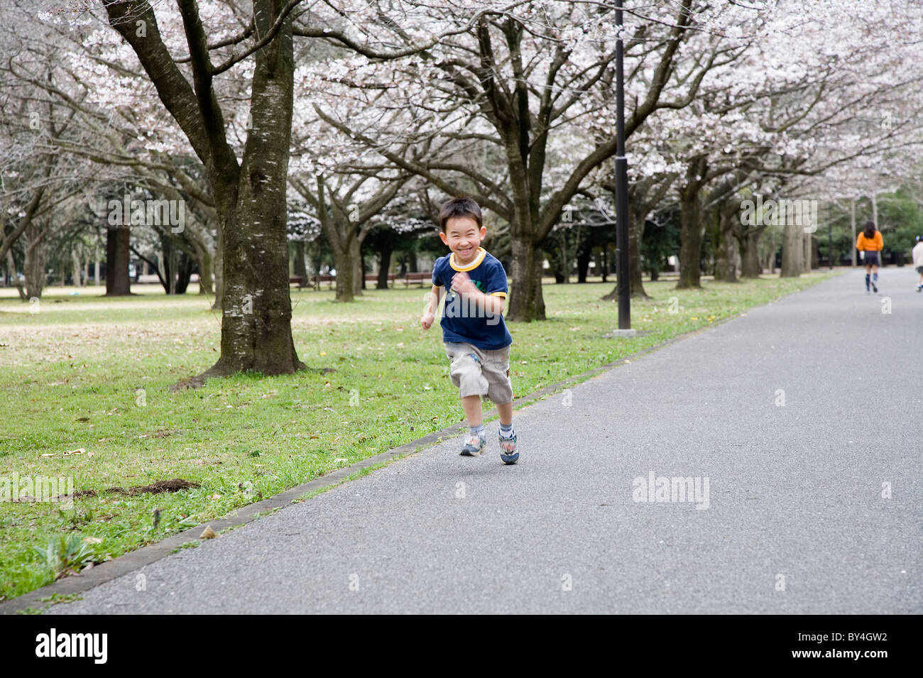 Boy Running in Park Stock Photo - Alamy