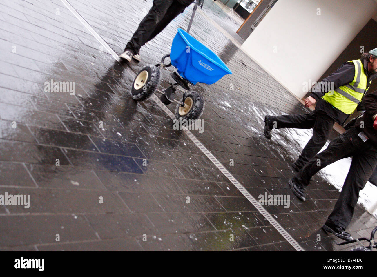 LONDON, UK. Council workers grit the pavements near Waterloo Station ...