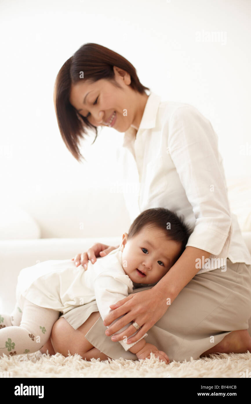 Baby Boy Lying on Mother's Lap Stock Photo - Alamy