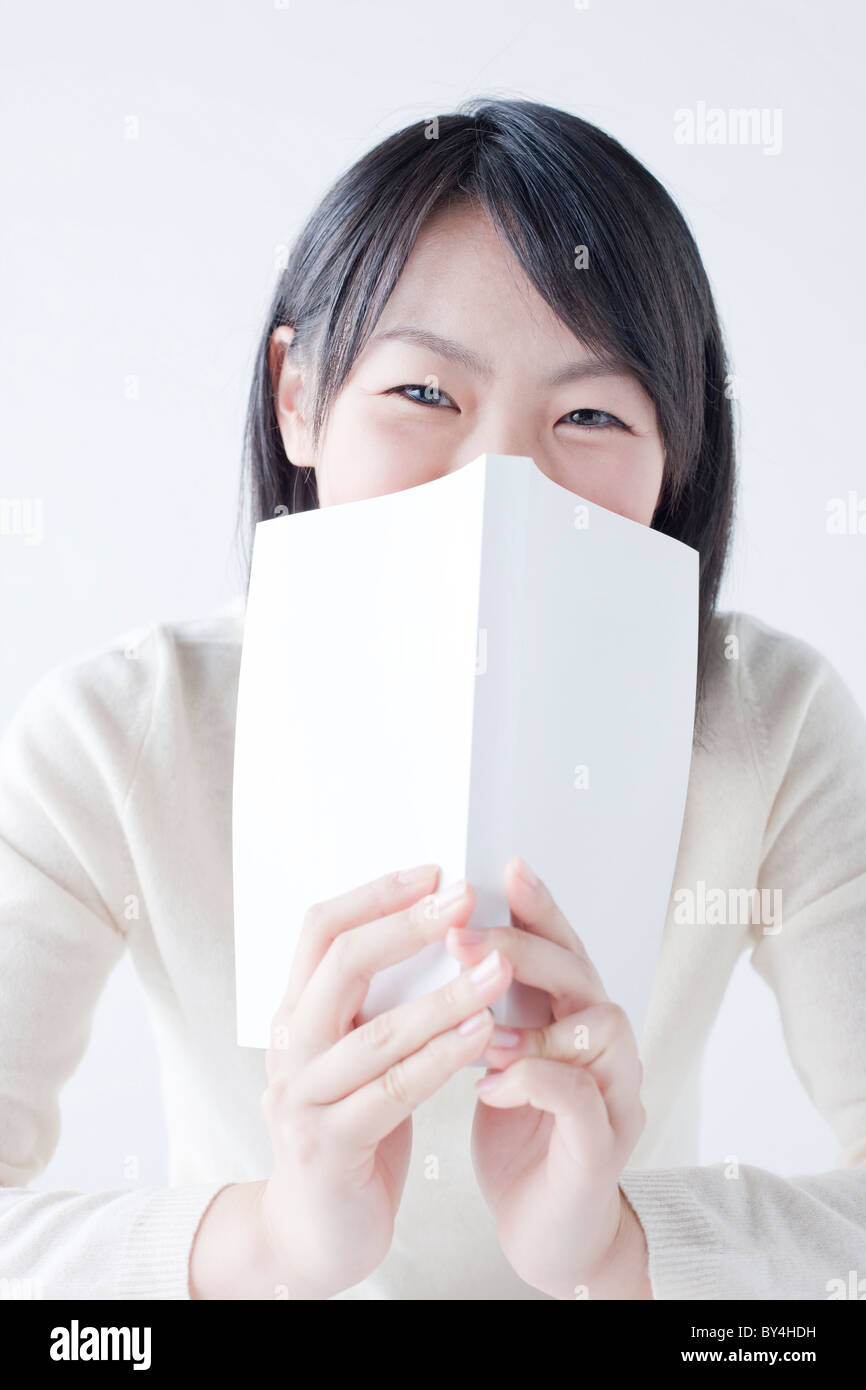 Teenage Girl Hiding Behind Book Stock Photo - Alamy