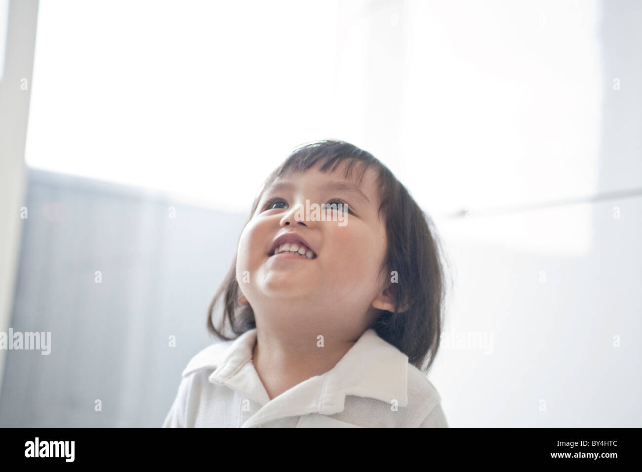 Baby boy looking up and smiling Stock Photo - Alamy