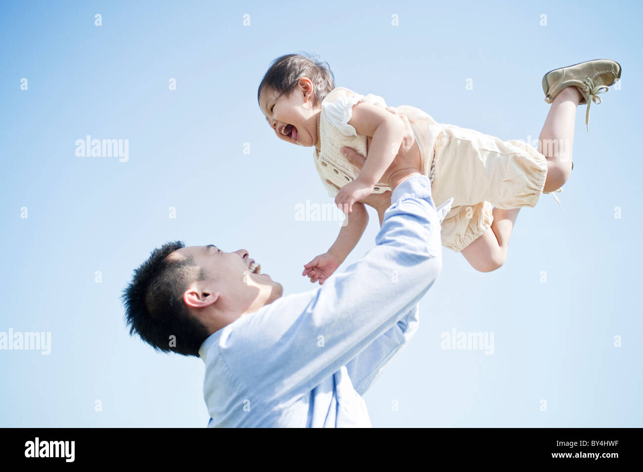 Father lifting up daughter Stock Photo - Alamy