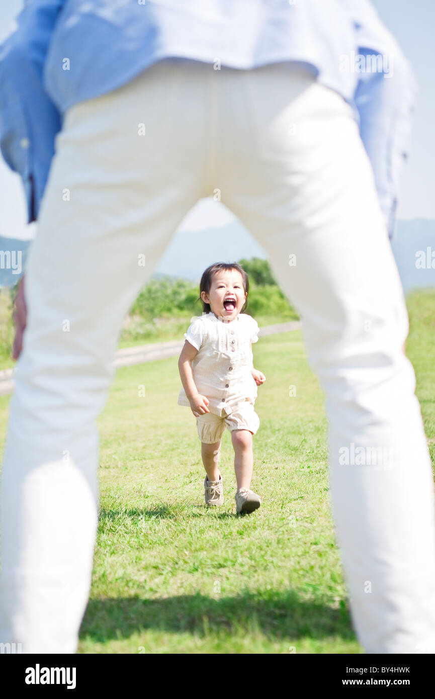 Girl running to father Stock Photo - Alamy