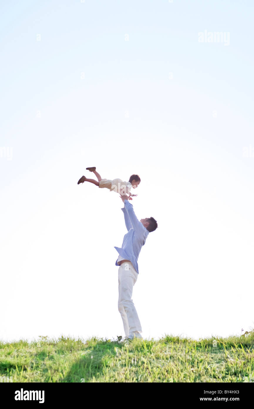 Father lifting up daughter Stock Photo - Alamy