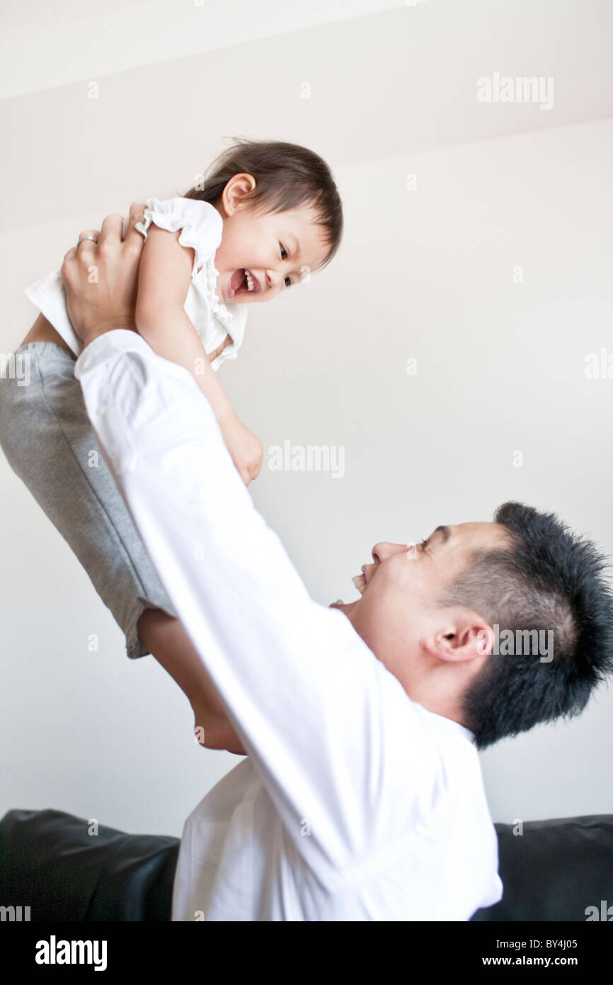 Father lifting up daughter Stock Photo - Alamy
