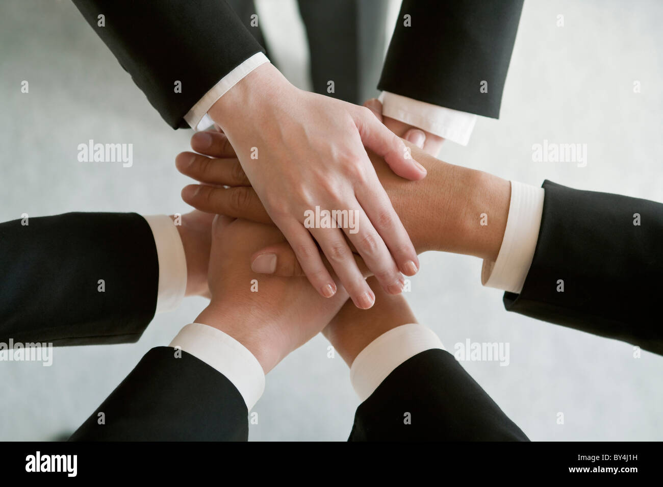 Business people stacking hands Stock Photo - Alamy