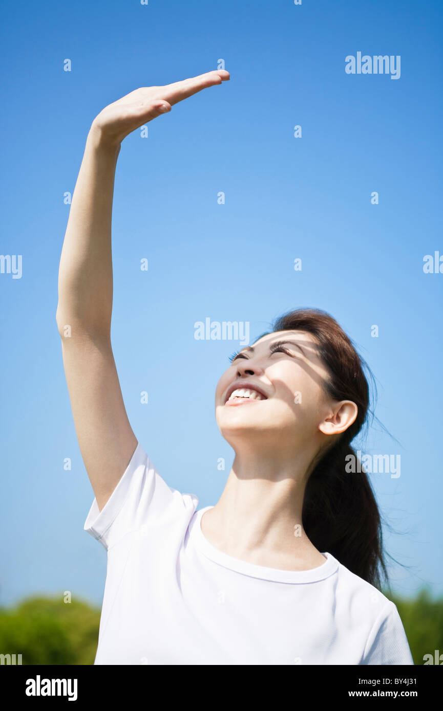 Woman with her hand raised Stock Photo - Alamy