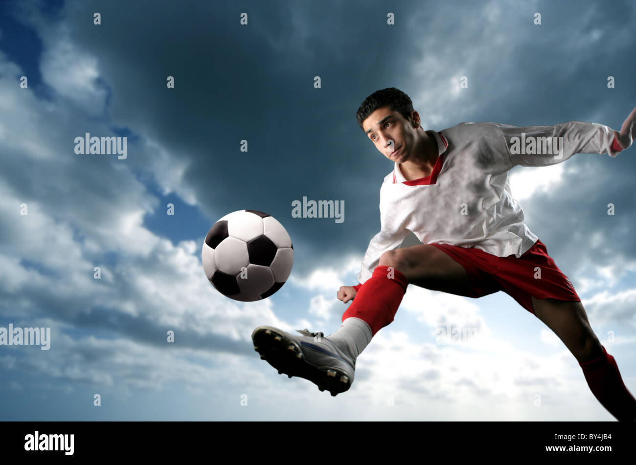 Boy in flight kicks a ball Stock Photo - Alamy