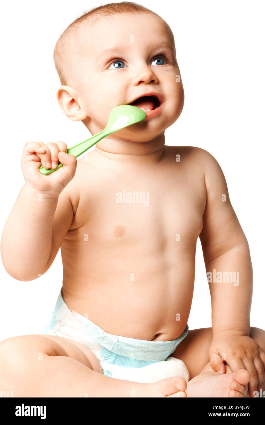 Adorable baby with spoon in mouth looking aside and having fun Stock ...